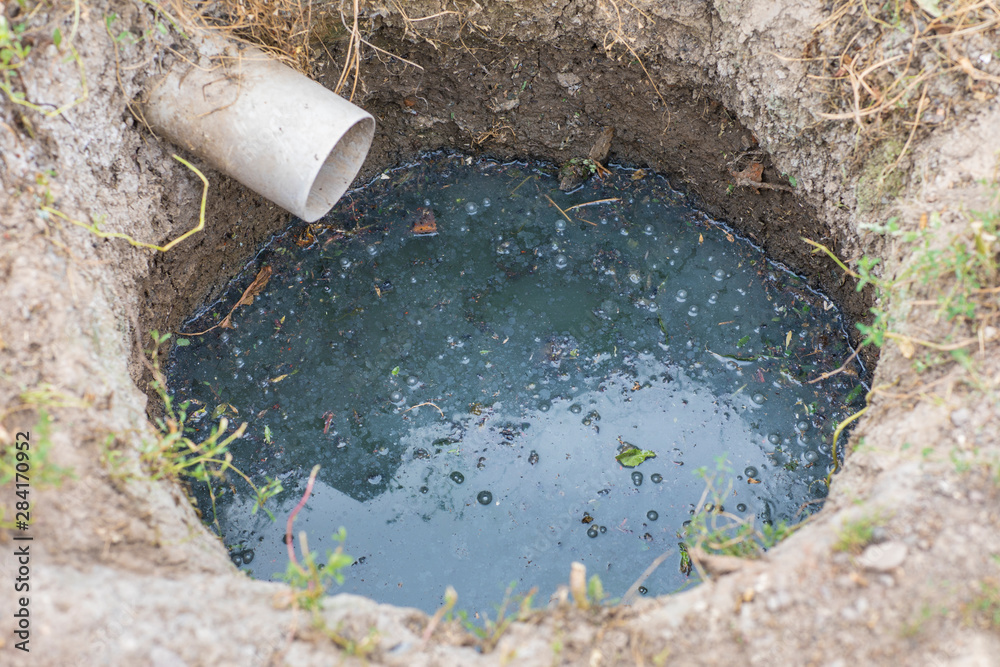 discharge of dirty water into a pit Stock Photo | Adobe Stock