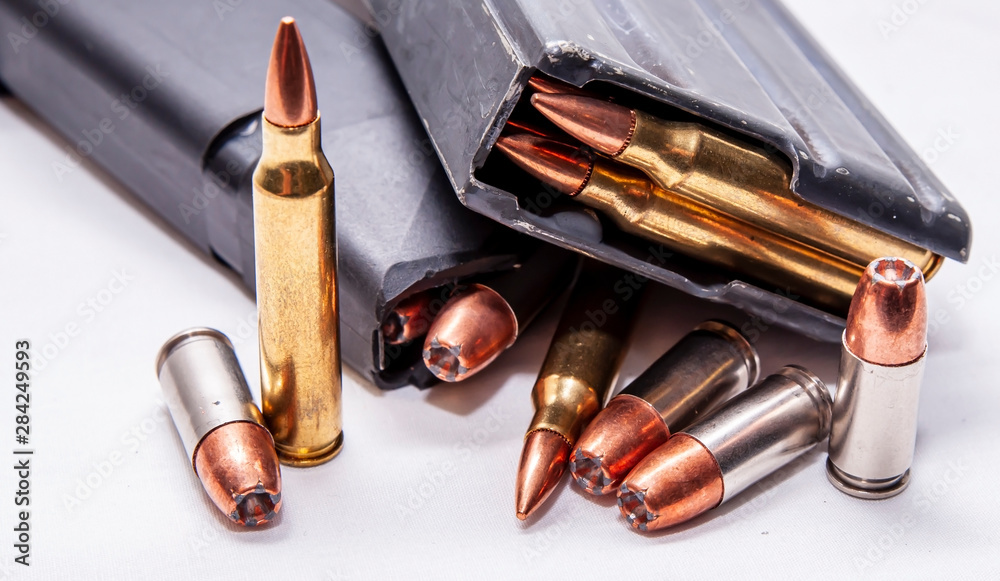 Two loaded magazines, one for a 223 caliber rifle and the other for a ...