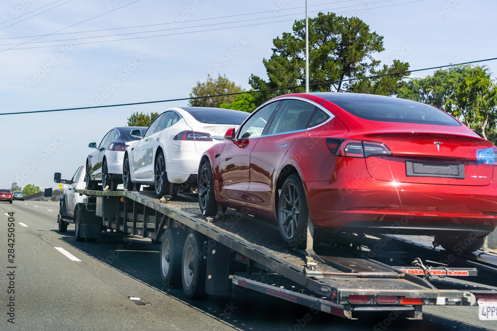 April 26, 2019 Redwood City / CA / USA - Car transporter carries Tesla ...