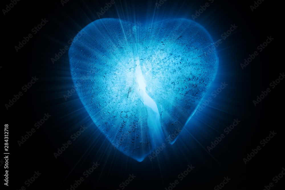 Ice frozen broken in half heart symbol of blue color close-up glowing ...
