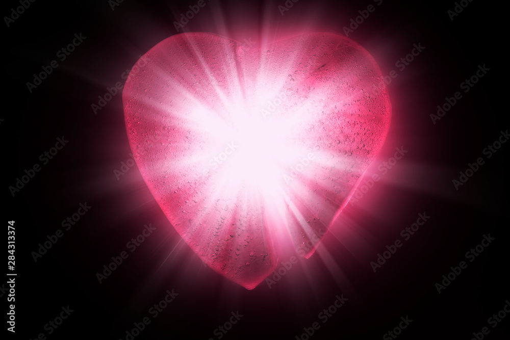 Ice frozen broken in half heart symbol of a soft pink color close-up ...