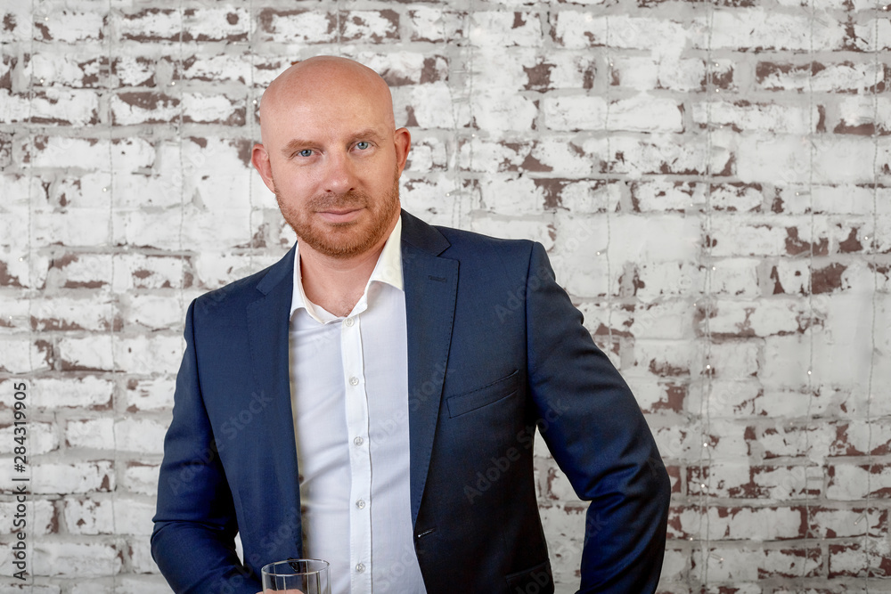 Successful male bald businessman poses for the camera and shows class ...