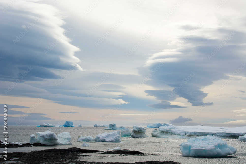 Antarctica. Brown Bluff. Lenticular clouds show katabatic winds are ...