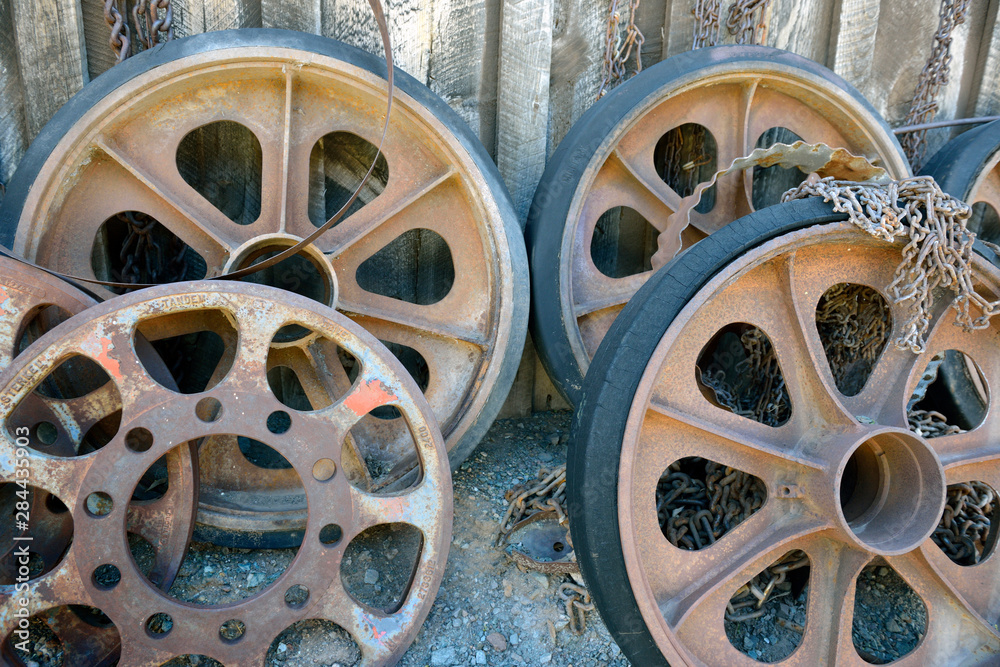 USA, Arizona, Jerome, Gold King Mine. Selection of rusted wheels with ...