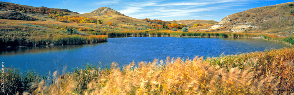 USA, North Dakota, Lewis & Clark SP. Autumn light slants over this deep ...