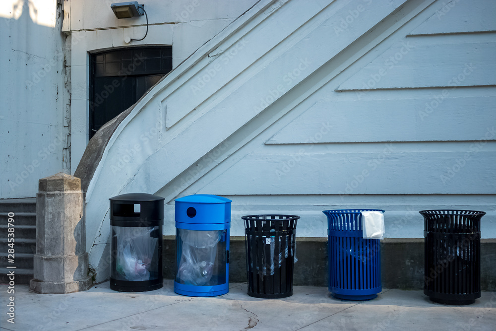 Trash and reclying cans lined up next to stairwell in Chicago Loop ...