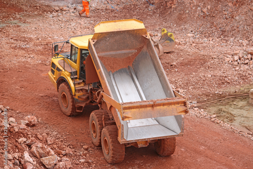 Dump truck tipping on a road construction site Stock Photo | Adobe Stock
