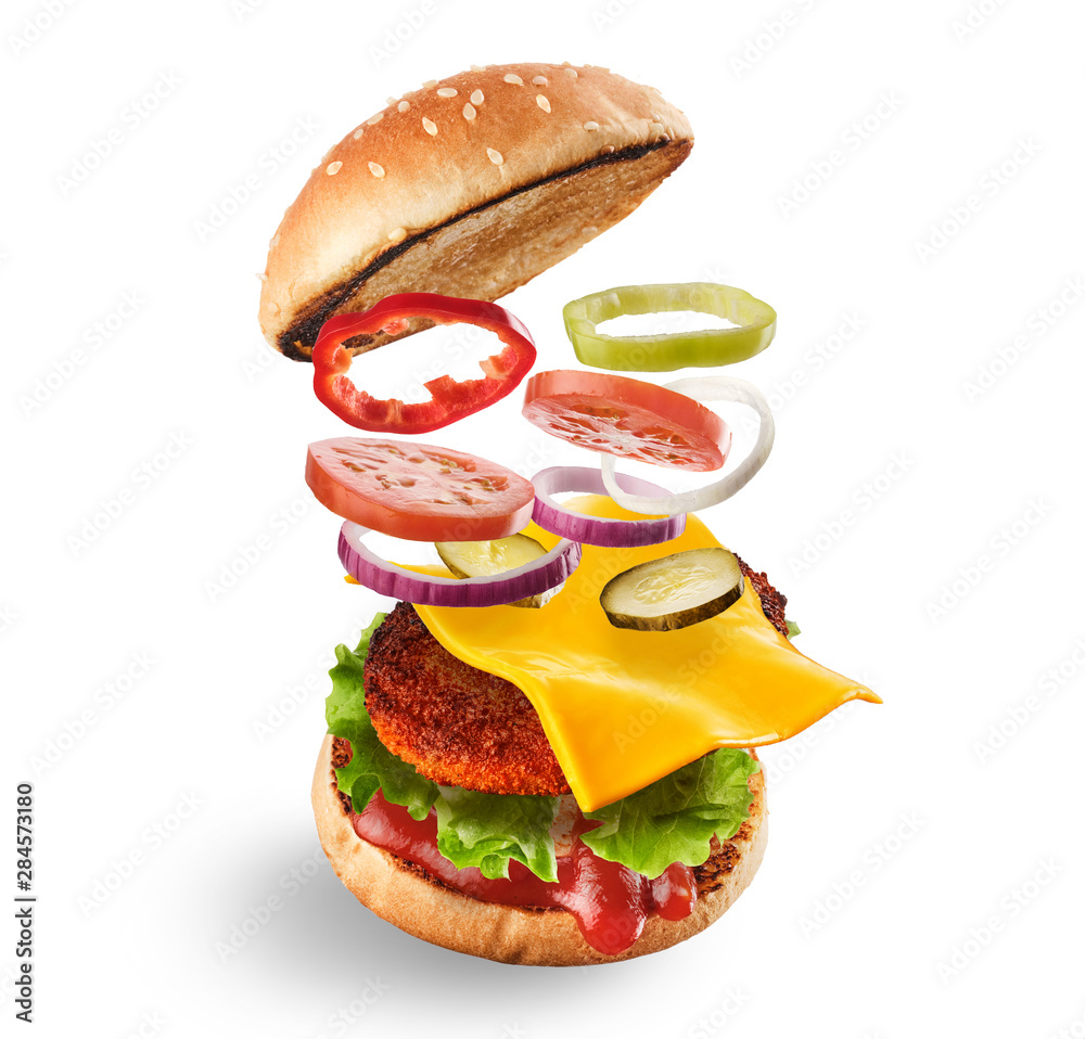 Burger with flying ingredients. Delicious monster Hamburger ...