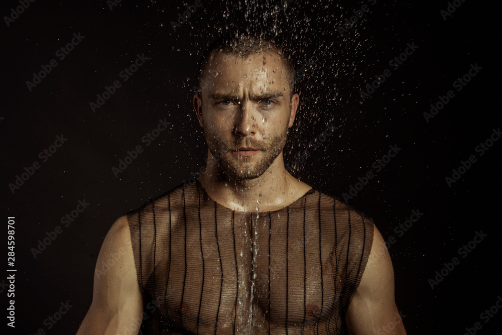 Strong stripped muscle male model in black fabric on black isolated ...