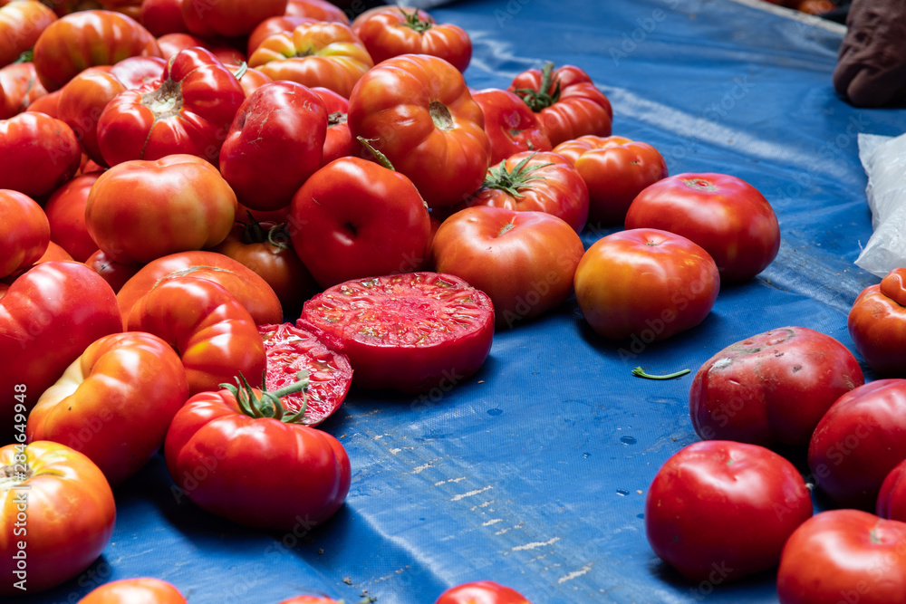 Fresh red heirloom tomato (also known as heritage tomato) at market ...