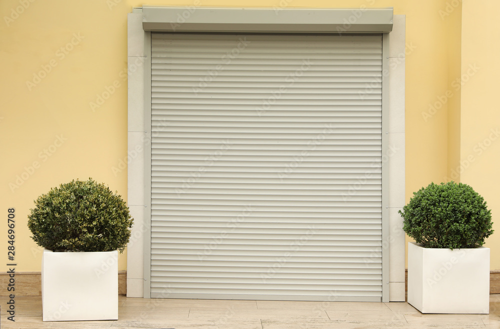 Building with closed roller shutter door. Exterior design Stock Photo ...