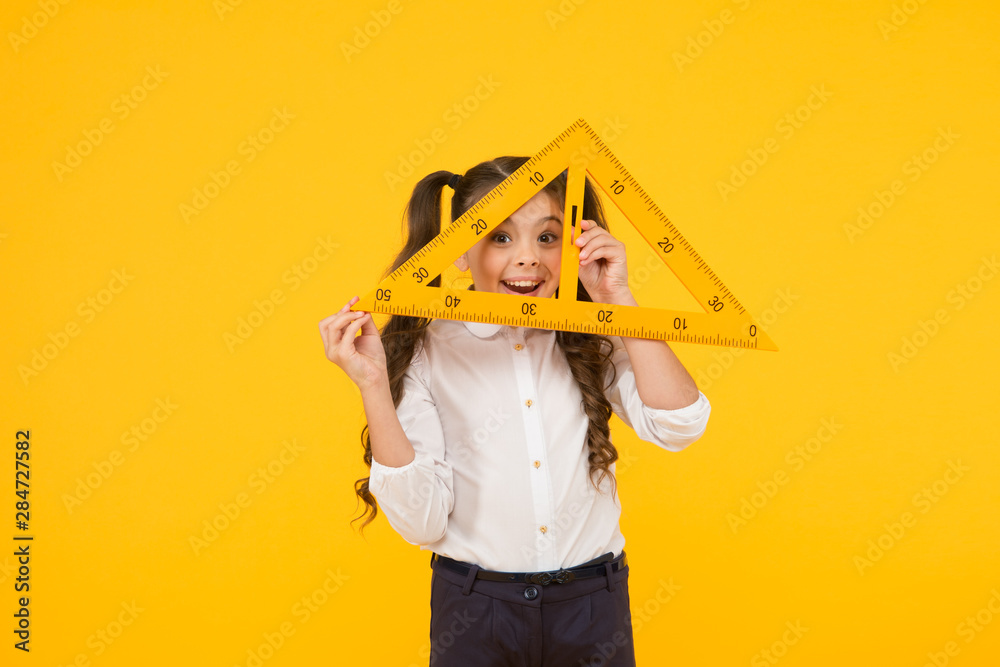 Knowledge day. Schoolgirl school uniform hold big ruler geometry school ...
