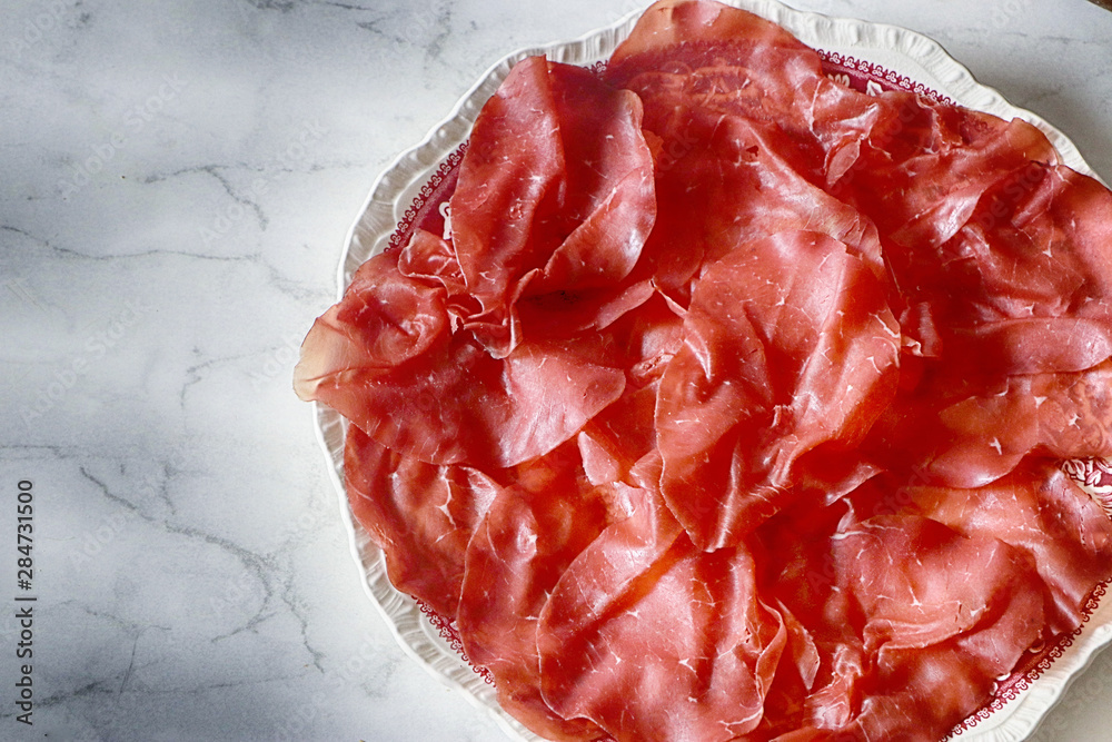 Photo & Art Print Italian bresaola: dry salted beef raw ham seasoned ...