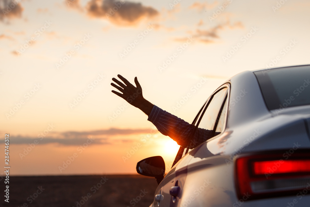 Man inside car showing his hand outdoor/leaning out of car window at ...