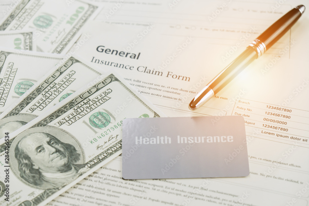 health insurance card and bank note and pen on background of general ...