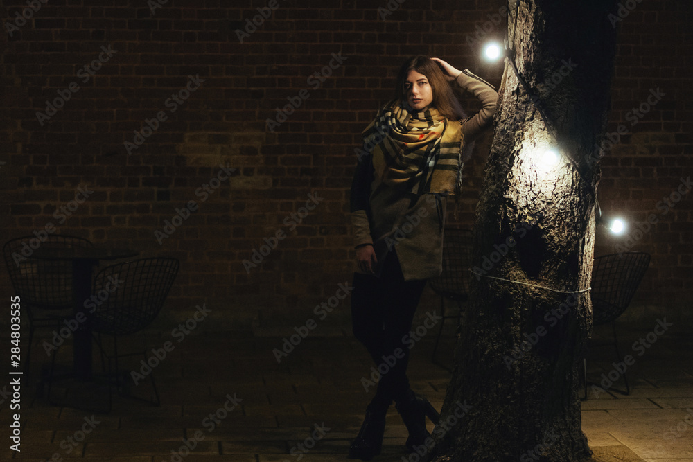 Sexy young beauty woman posing over night city illuminated street ...