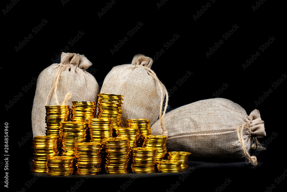 Stacking gold coin in treasure sack Stock Photo | Adobe Stock