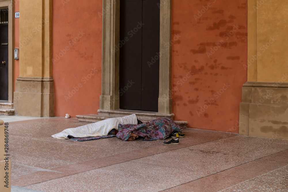 Poor homeless people or refugees sleeping on an urban street in the ...