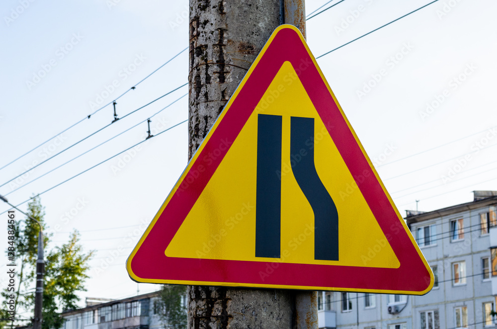 Road sign narrowing the road (temporary). Repair work on the repair of ...