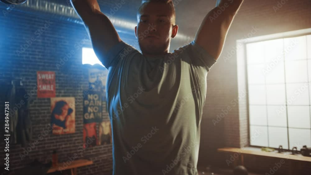 Handsome Muscular Man Does Overhead Deadlift with a Barbell in a Small ...