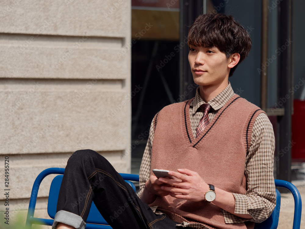 Portrait of a handsome Chinese young man with Korean style clothes ...