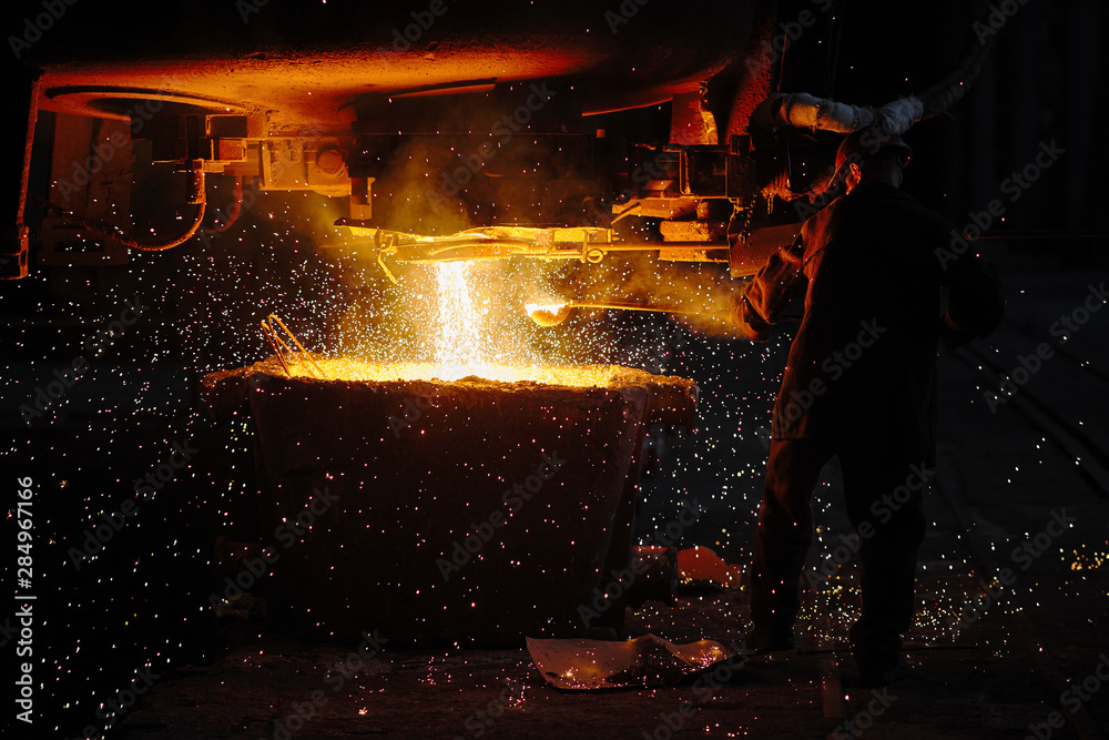 Steelmaker at ingot casting. Electric arc furnace shop EAF. Metallurgy ...