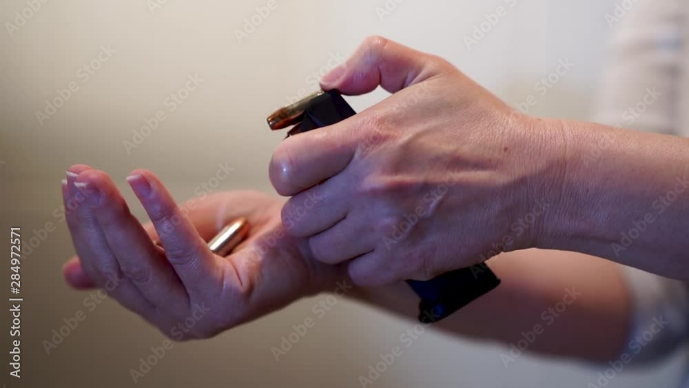 This footage is a High Definition video of a woman removing the bullets ...