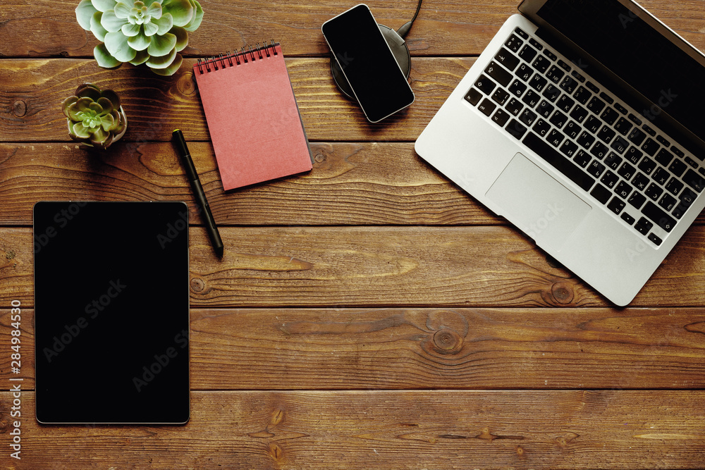 Office table workspace top view. Wooden desk with laptop, devices and ...