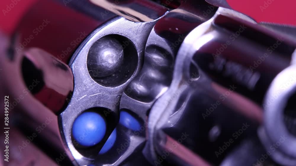Frontal view of revolver from chambers panning to muzzle close up ...