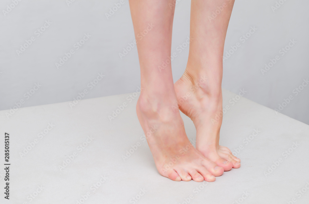 Beautiful female feet on gray background. Cosmetology, pedicure, foot ...