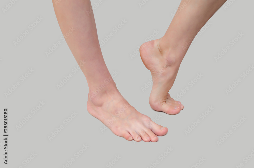 Beautiful female feet on gray background. Cosmetology, pedicure, foot ...