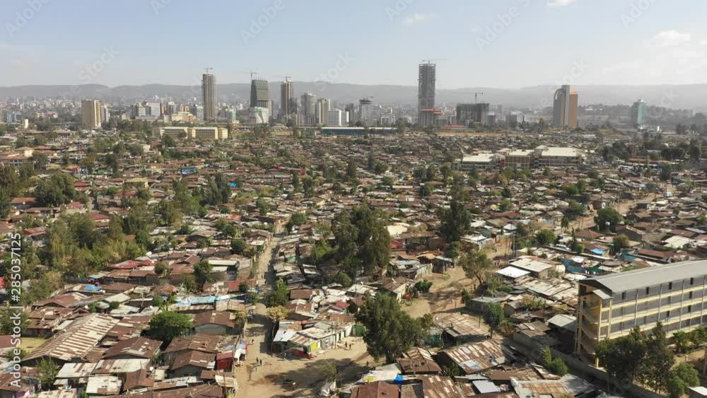 Flying over poor residential neighborhoods with rooftops made of ...