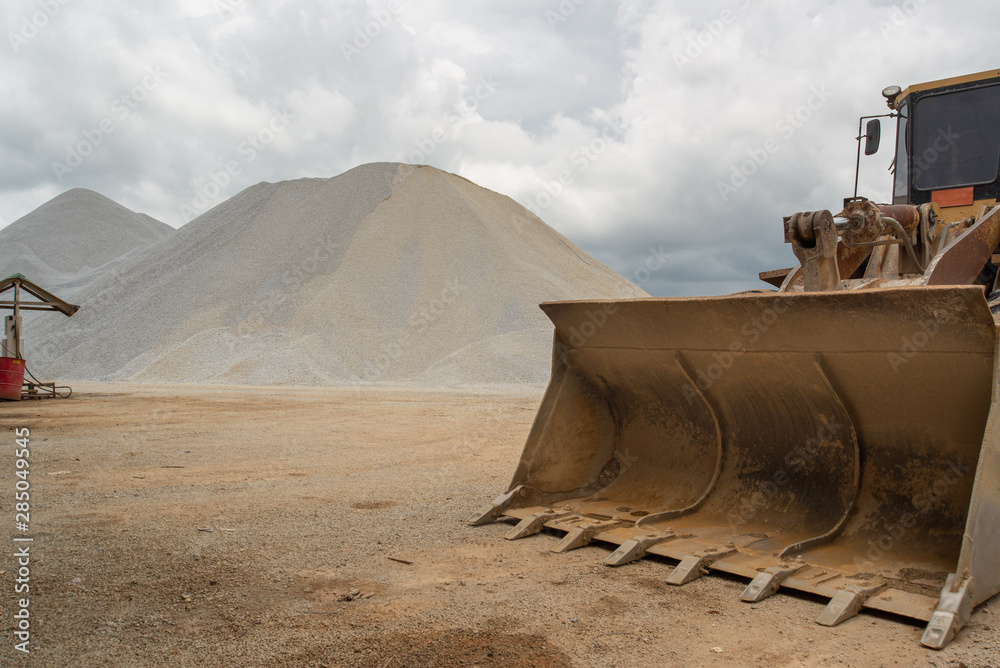 Excavators and heavy machinery in the works of stone movement in a ...