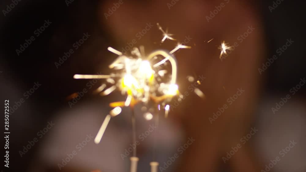 Sparklers fizz on a cake for an excited young girls 10th birthday ...