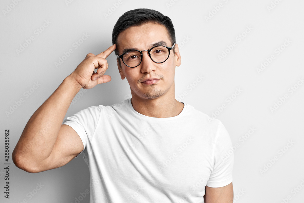 Portrait of smart thinking Kazakh man in glasses dressed in casual ...