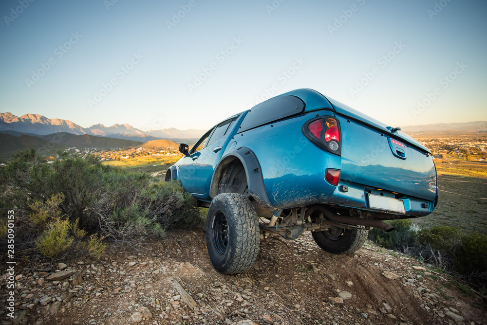 Close up wide angle image of a modified 4x4 pick up truck driving on a ...