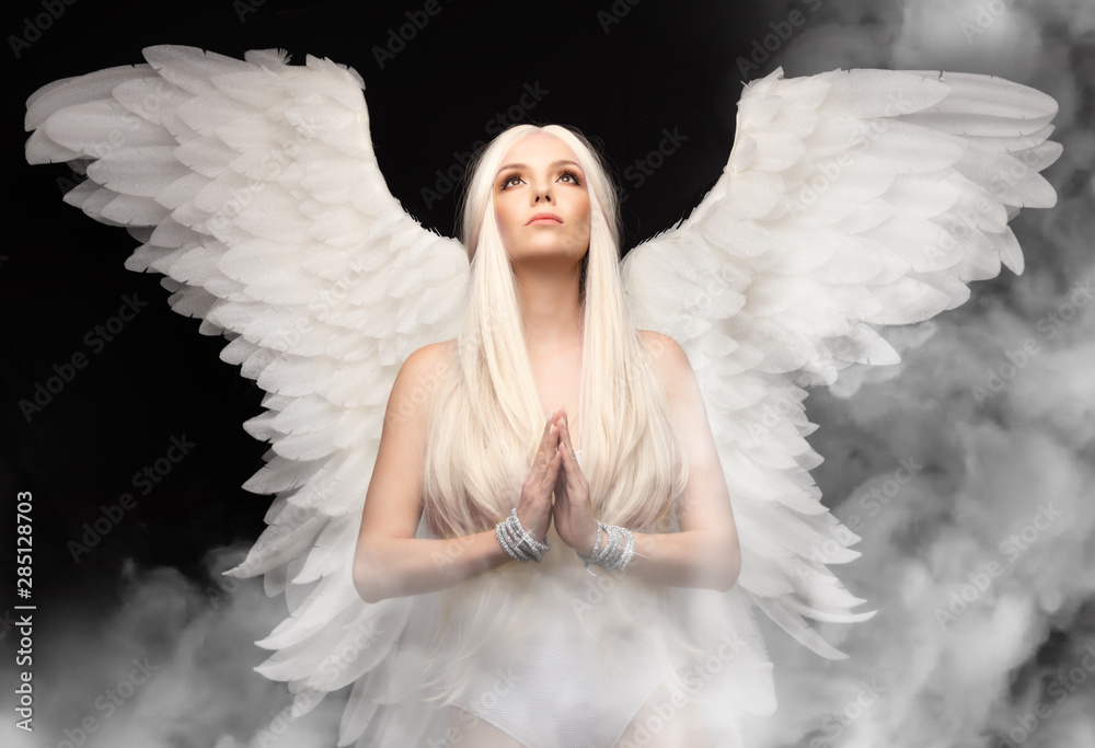 angel girl with white hair on black background, hands folded in prayer ...