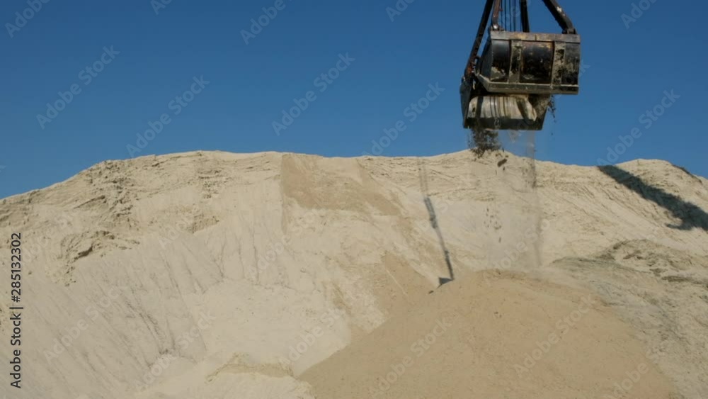 Extraction of river sand. Gantry cranes on the riverport loads sand ...