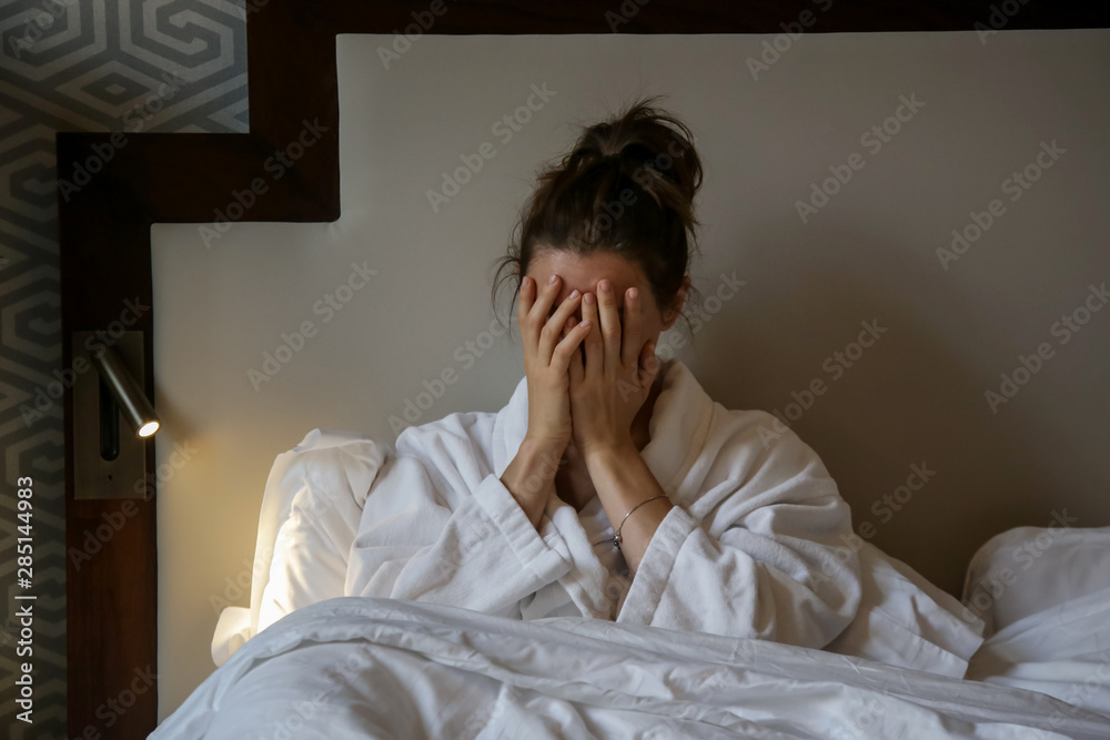 Young sad woman sitting in the bed, depression, anxiety, relationship ...