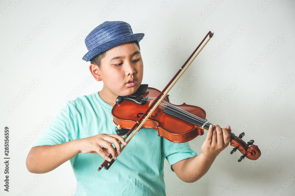 Asian children are playing violin instruments in the classroom. Stock ...