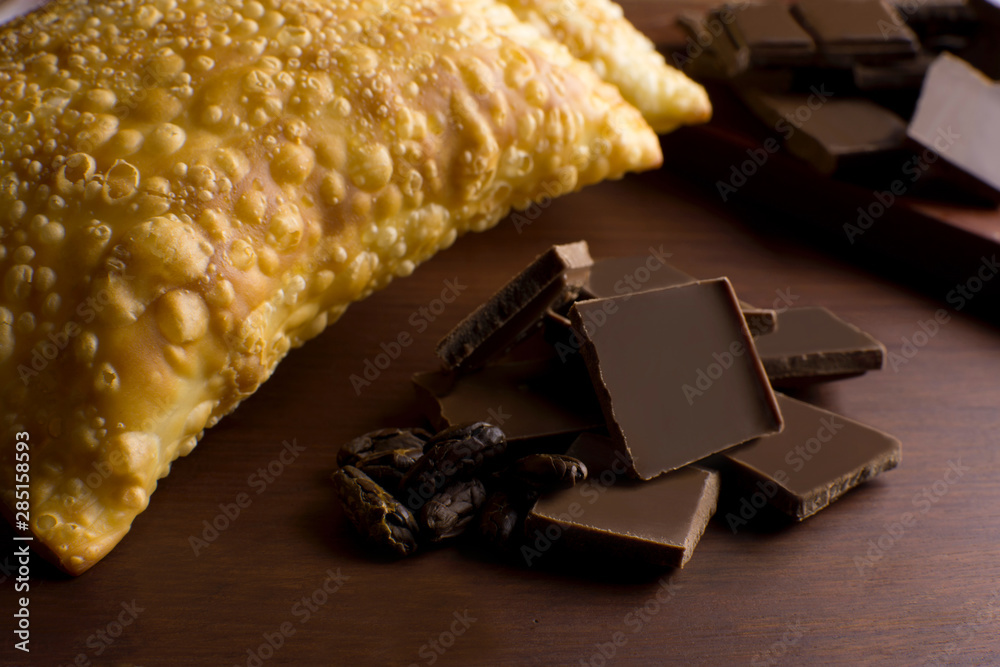 Chocolate pieces,roasted cocoa and tradional Brazilian fried pastry ...