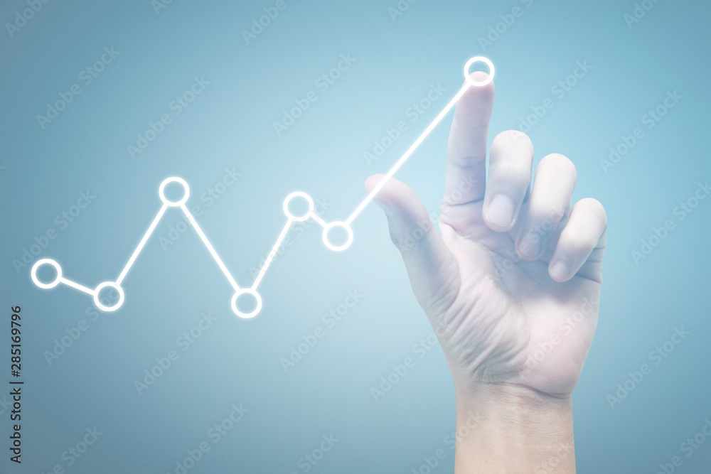 Hand touching graphs of financial indicator and accounting market ...