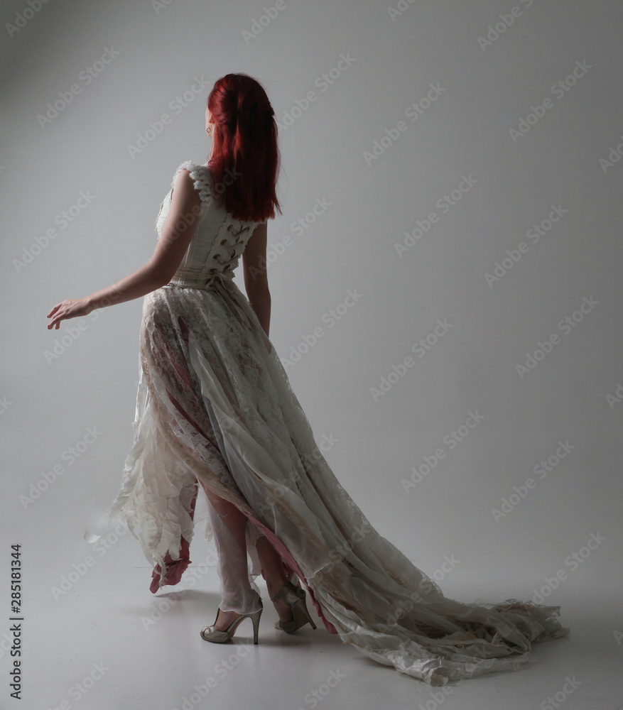 full length portrait of red haired girl wearing torn and tattered ...