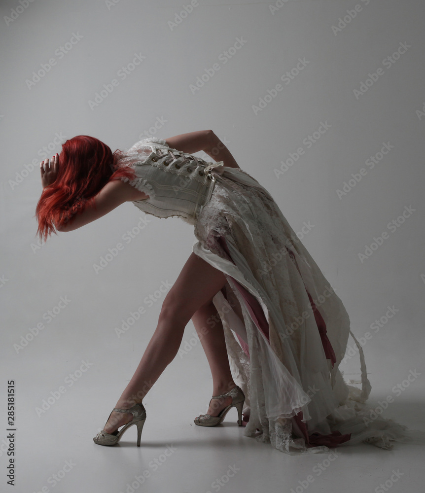 full length portrait of red haired girl wearing torn and tattered ...