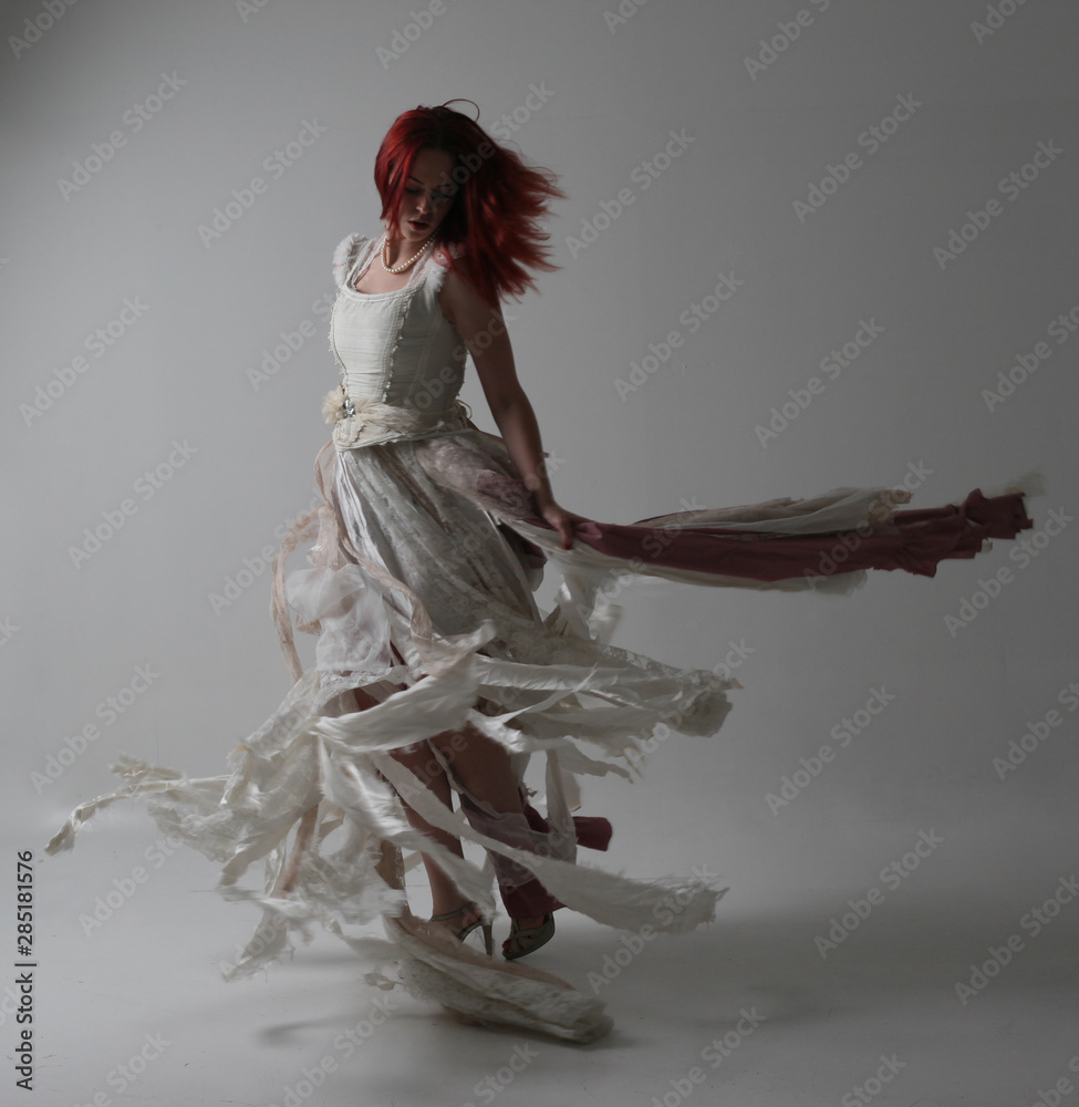 full length portrait of red haired girl wearing torn and tattered ...