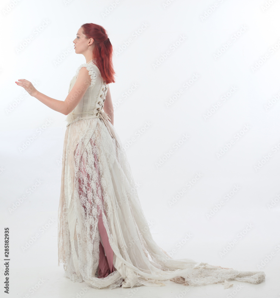 full length portrait of red haired girl wearing torn and tattered ...