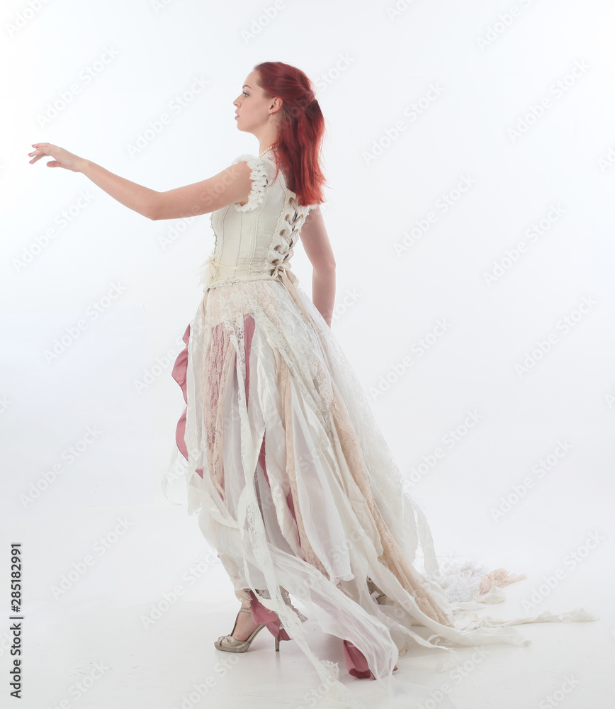 full length portrait of red haired girl wearing torn and tattered ...