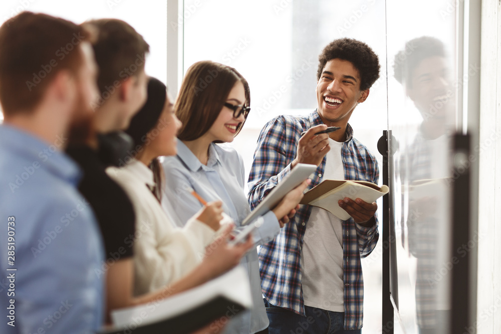 Students writing tasks on whiteboard in class Stock Photo | Adobe Stock