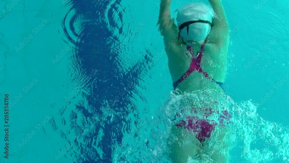 Girl Swimmer Dive In Swimming Pool. Female swimmer dives in swimming ...