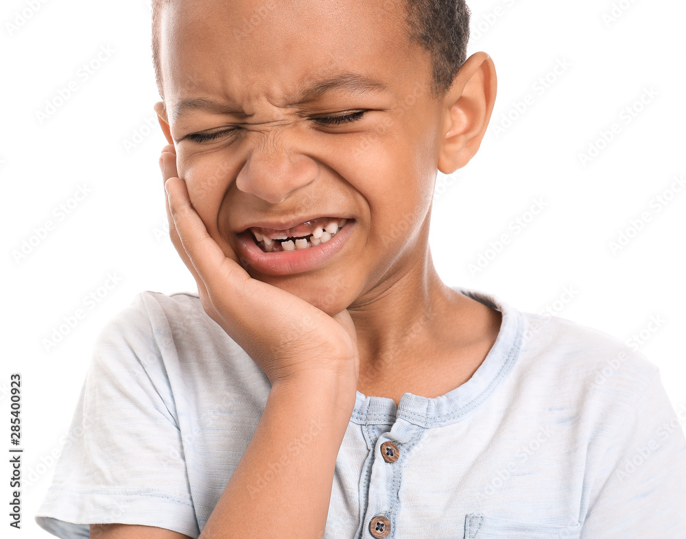 Little African-American boy suffering from toothache against white ...